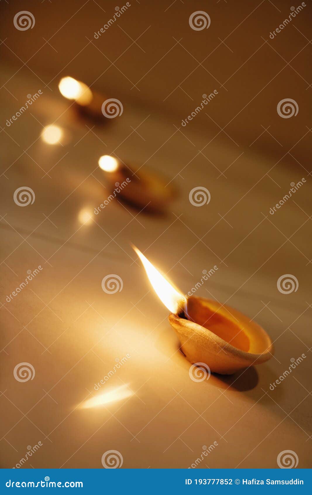 Lit oil lamps on the floor stock photo. Image of focus - 193777852