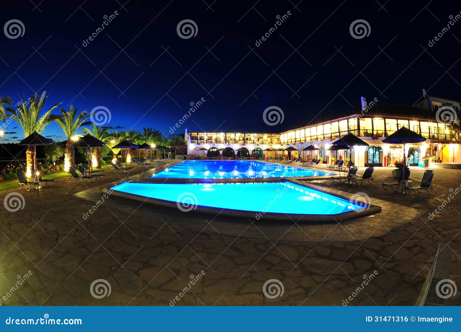 Lit Pool Area of a Resort at Night Stock Photo - Image of mirror, light ...