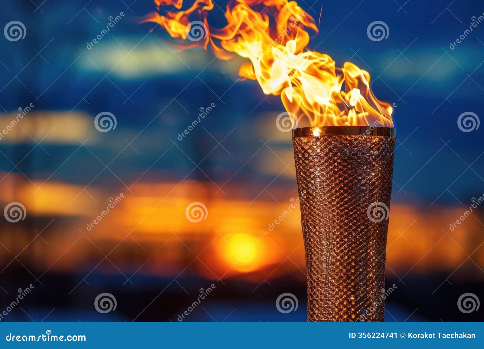 A Lit Torch is in the Foreground of a Sunset Stock Image - Image of ...