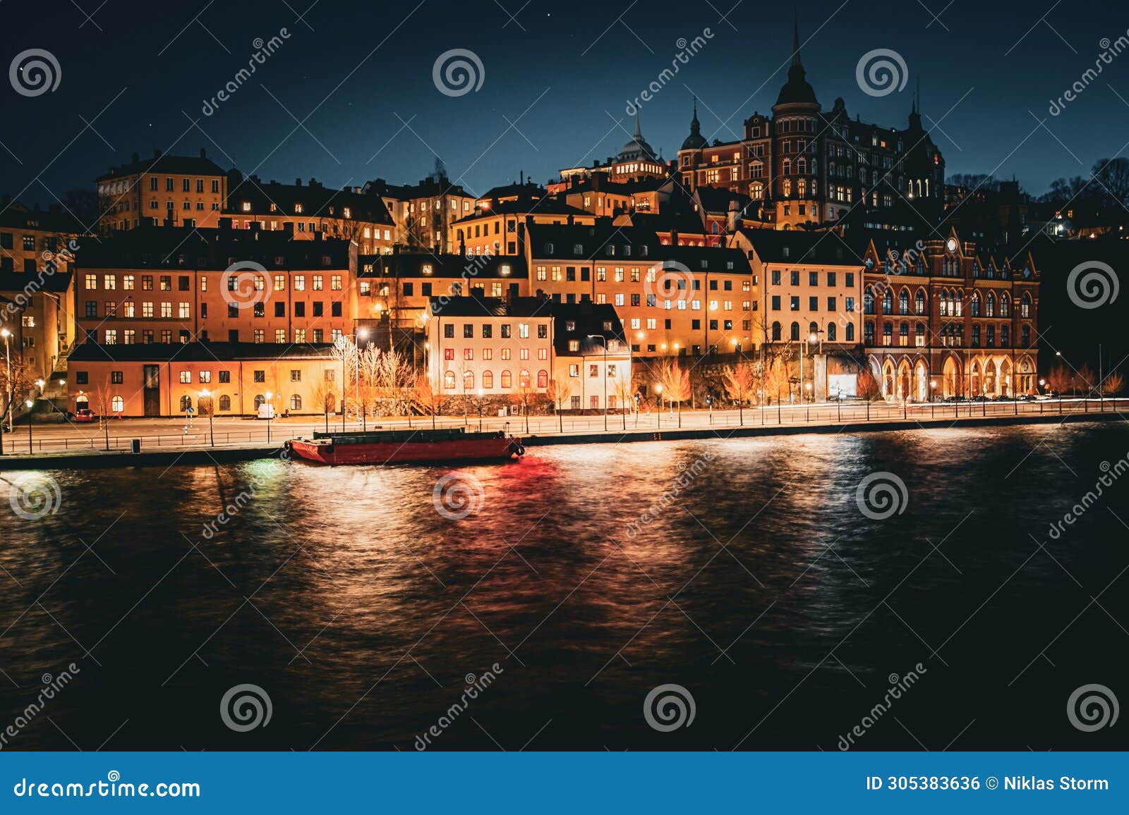 A Lit Up City at Night in Front of a River Stock Photo - Image of dusk ...