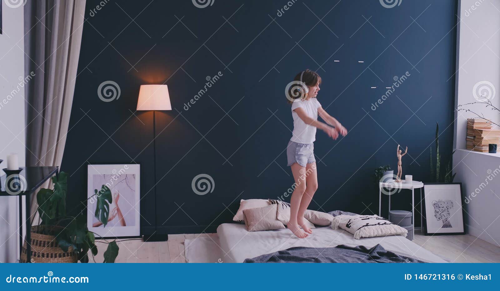 Litl Girl Dancing On Bed And Listening To Music With Wireless