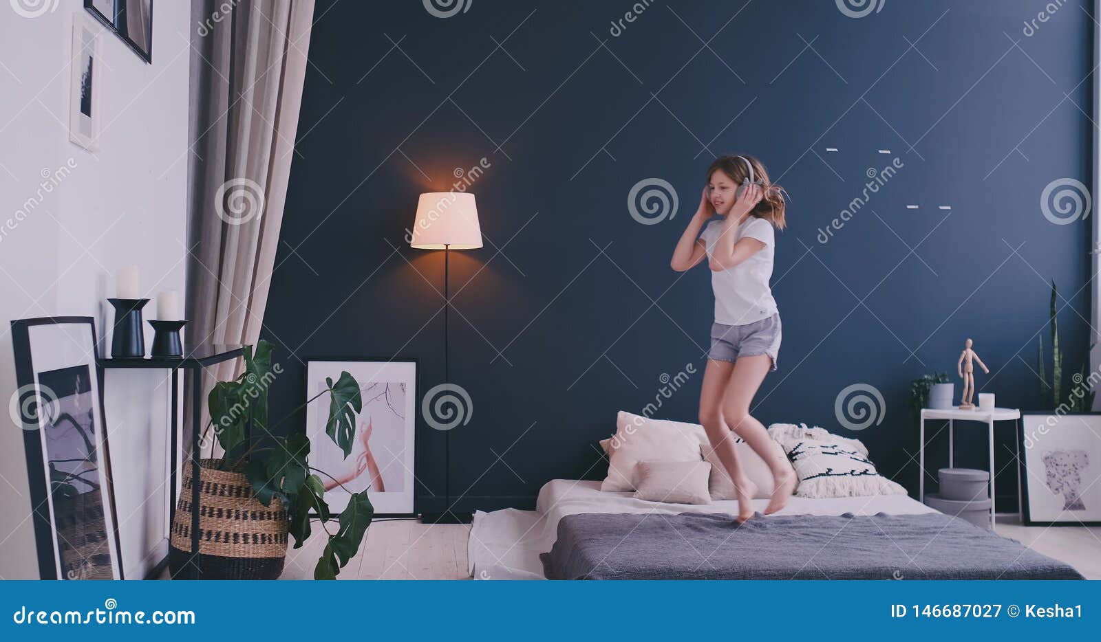 Litl Girl Dancing On Bed And Listening To Music With Wireless