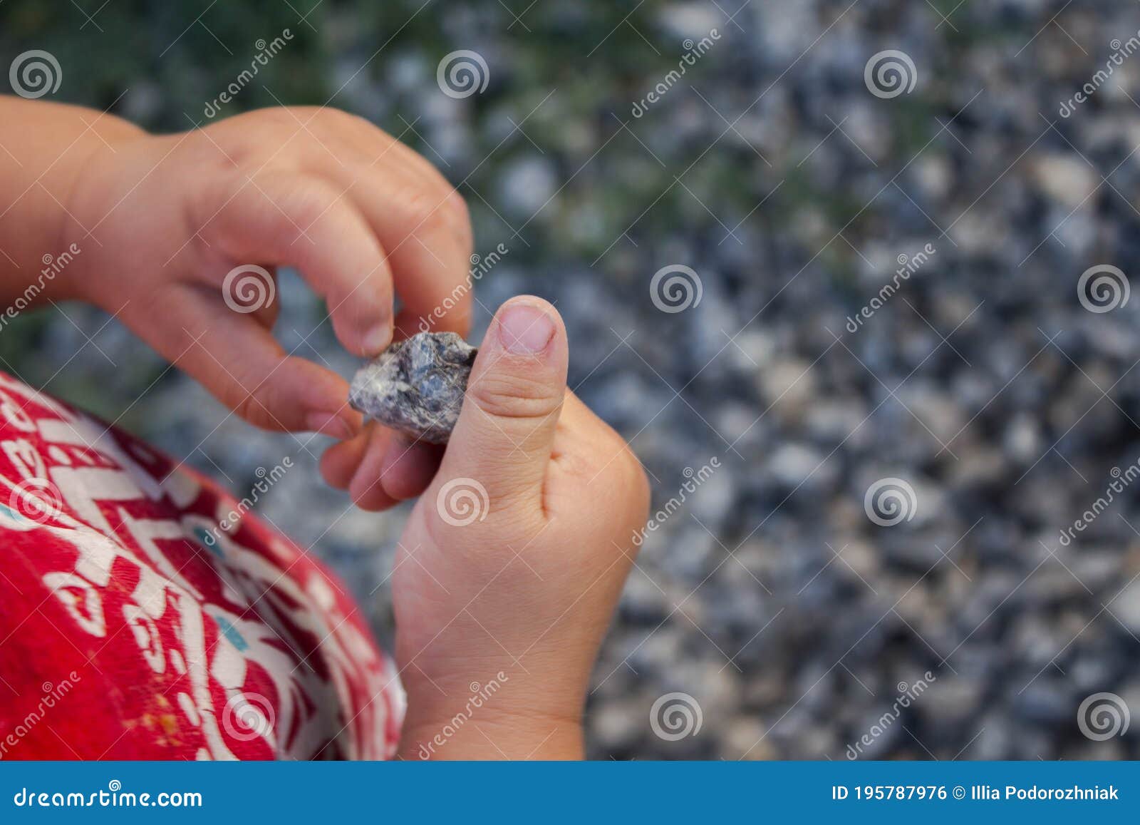 A Litlle Child Playing with Stones Pebble in Hand Stock Photo - Image ...
