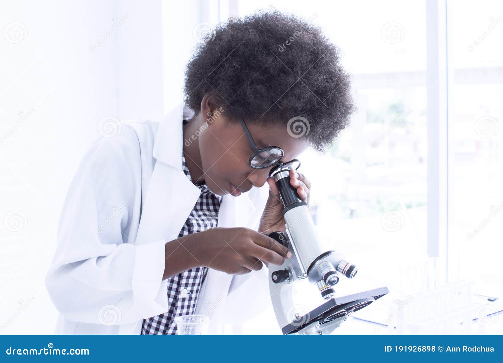 A Little African Boy Using Microscope in Classroom at School Stock ...