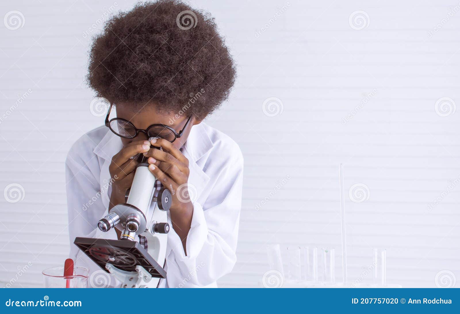 A Little African Boy Using Microscope in Classroom at School Stock ...