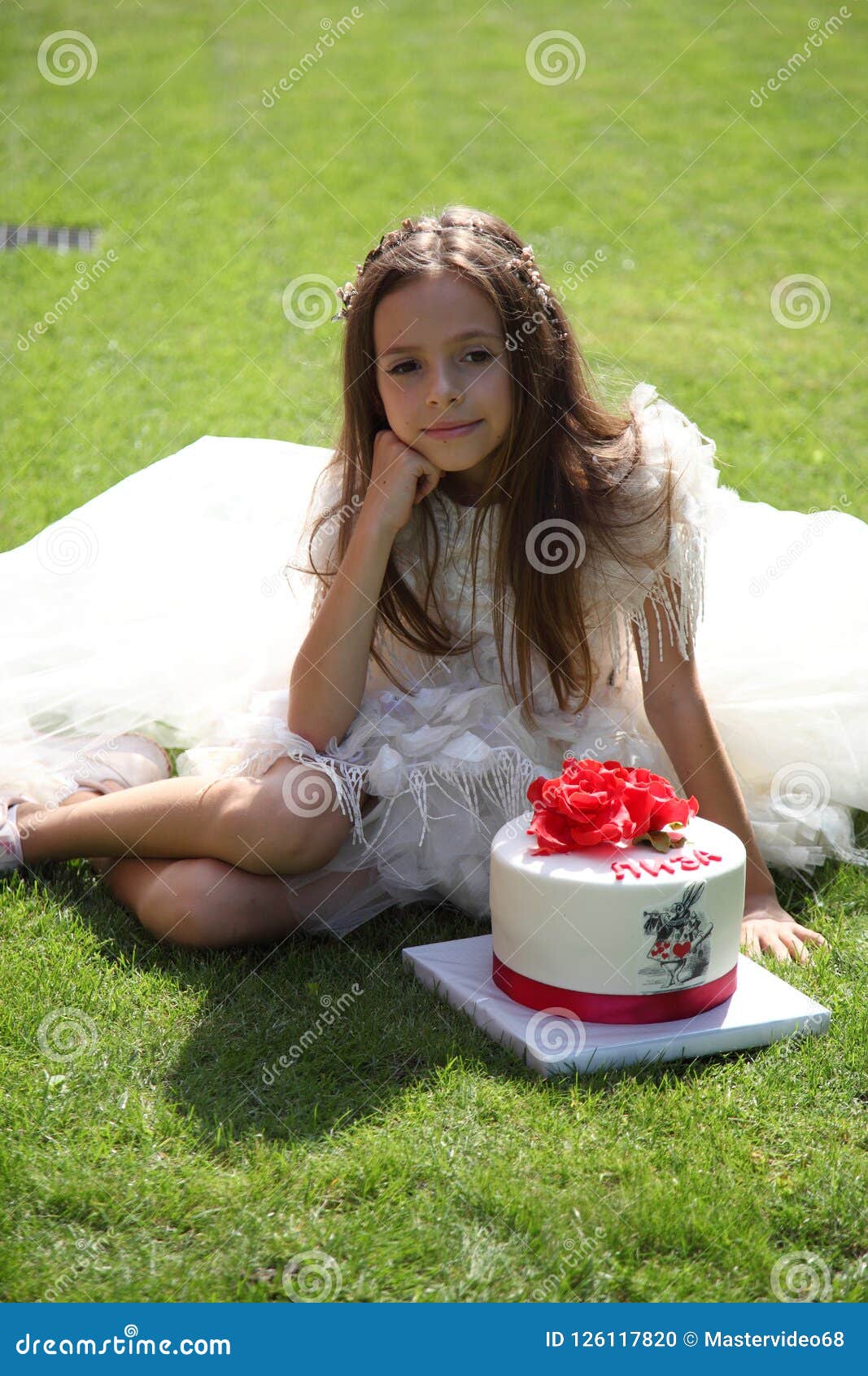 Little Alice is Sitting on the Grass. Alice and Cake. Stock Photo ...