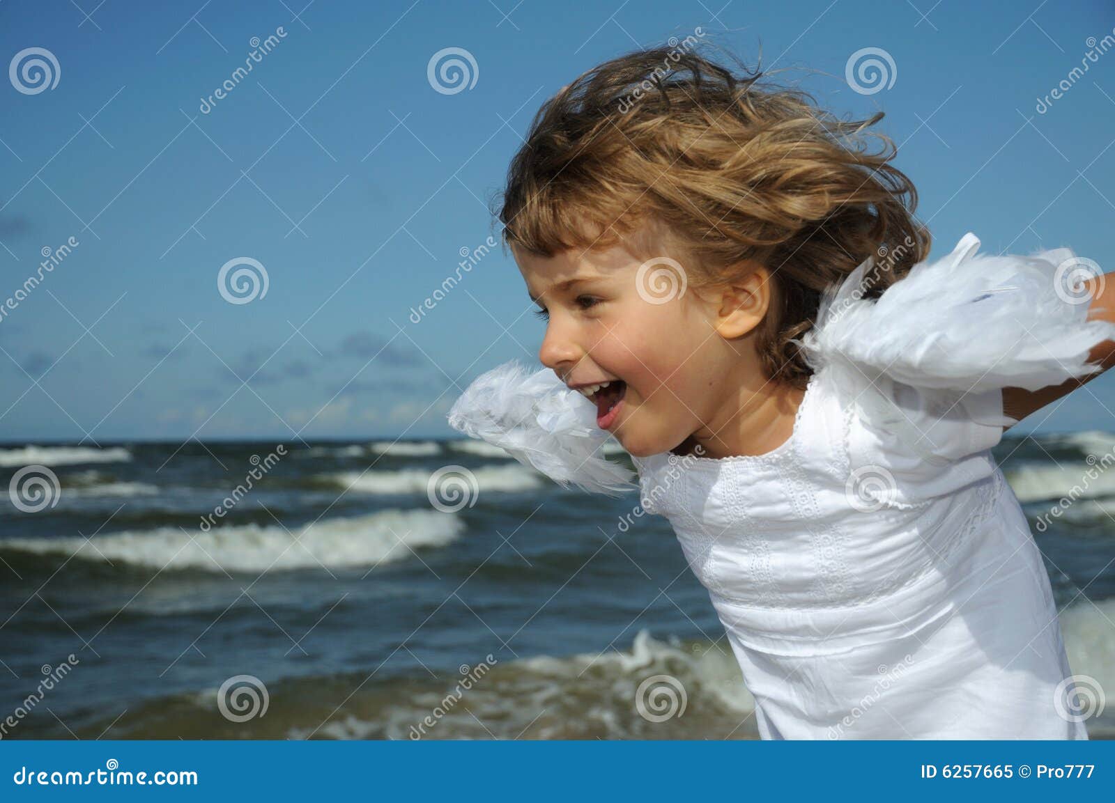Little angel on the beach stock image. Image of dress - 6257665