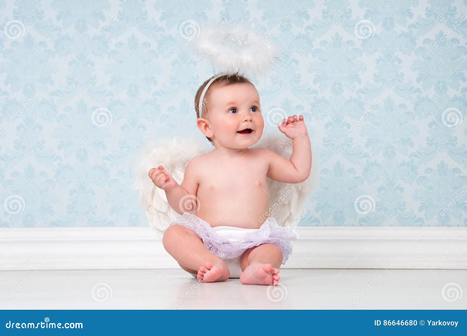 Little Angel Smiling and Sitting on the Floor. Stock Photo - Image of ...