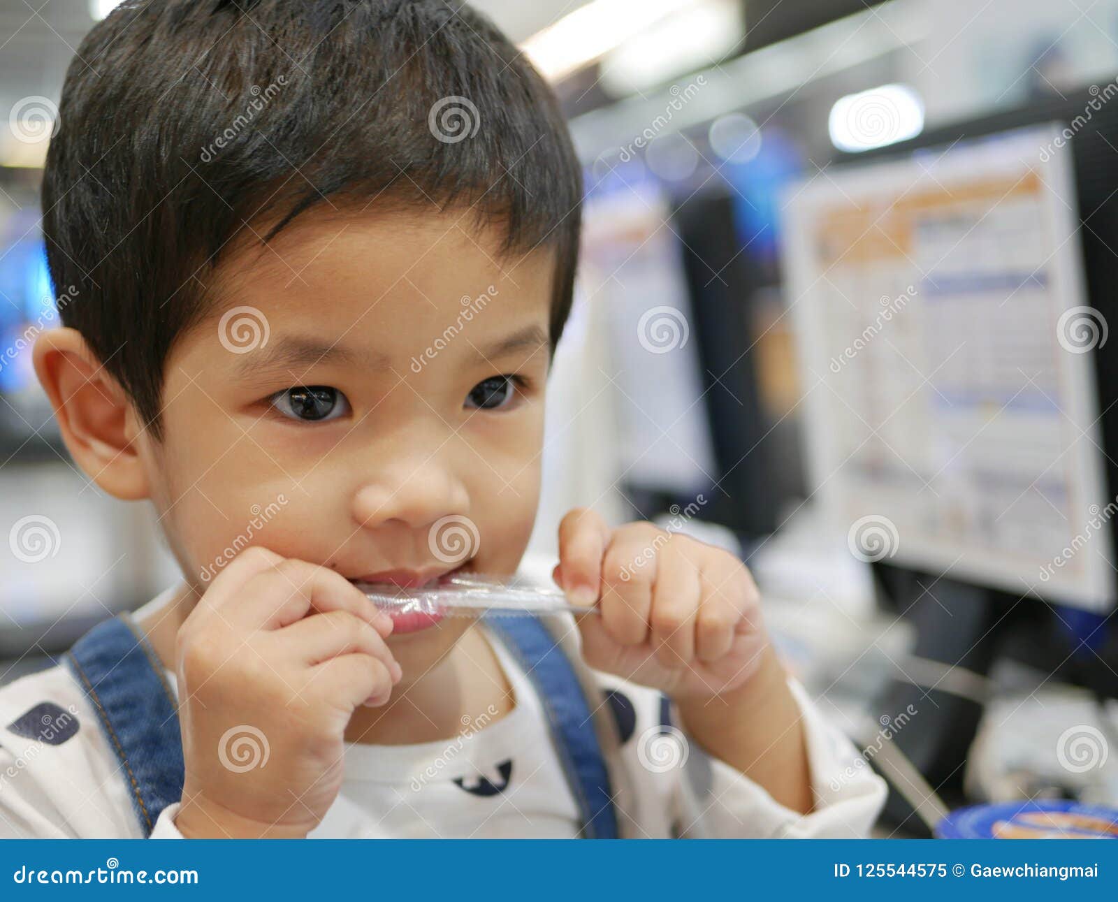 Little Asian Baby Taking a Straw Out from Its Package by Using Her ...