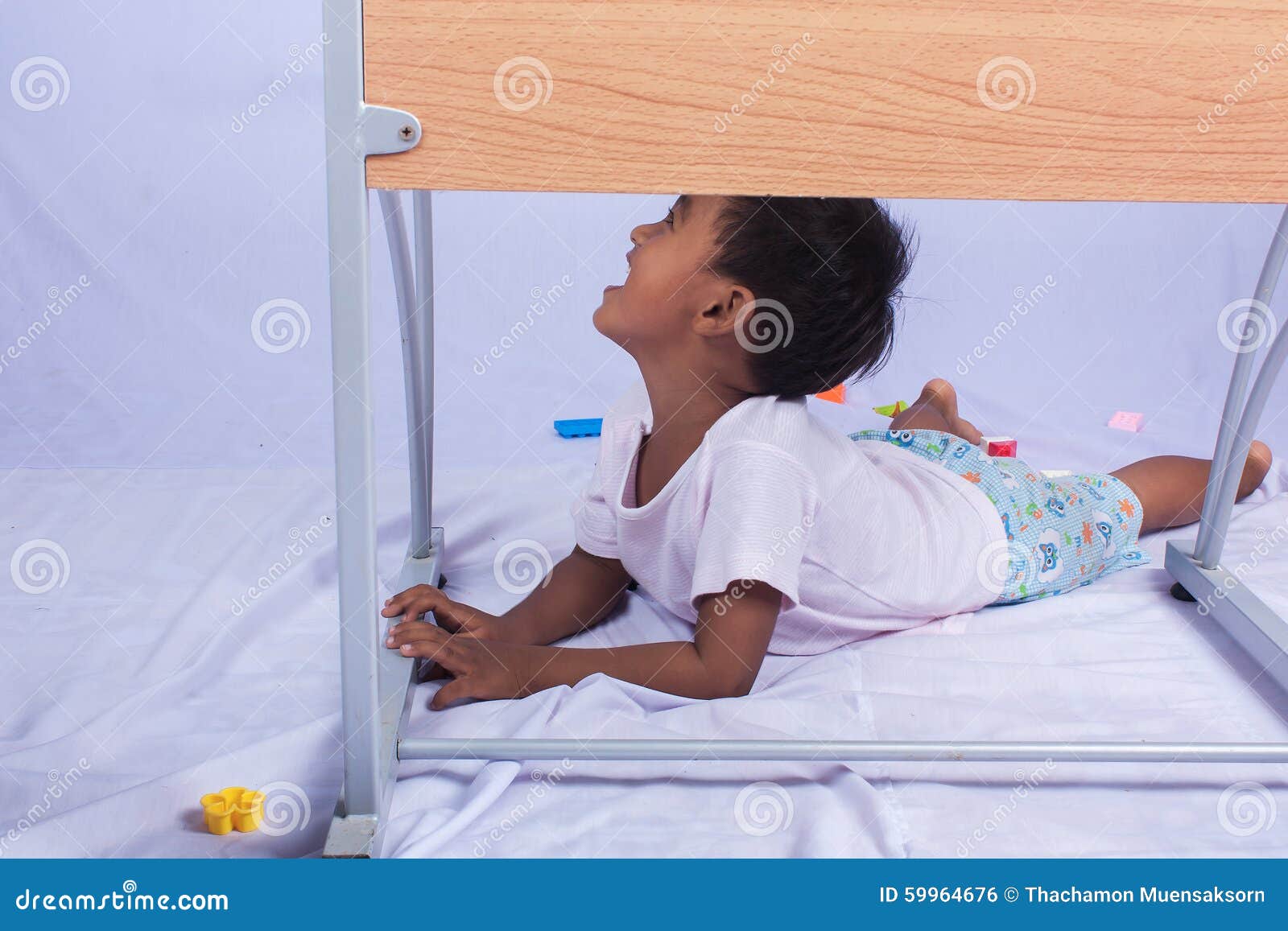 A Little Asian Boy Lying Under the Table Stock Photo - Image of beauty ...