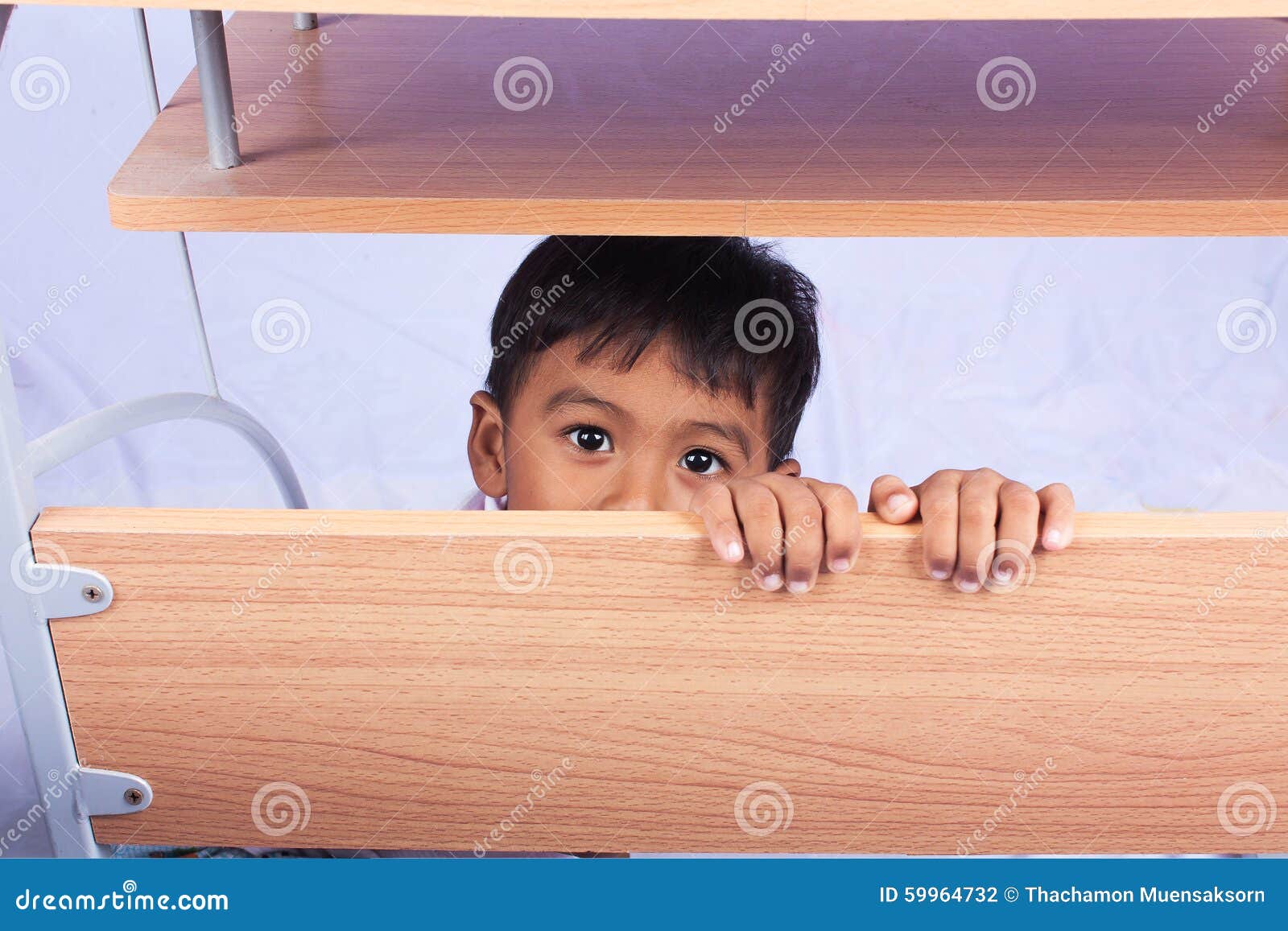 A Little Asian Boy Lying Under the Table Stock Photo - Image of model ...