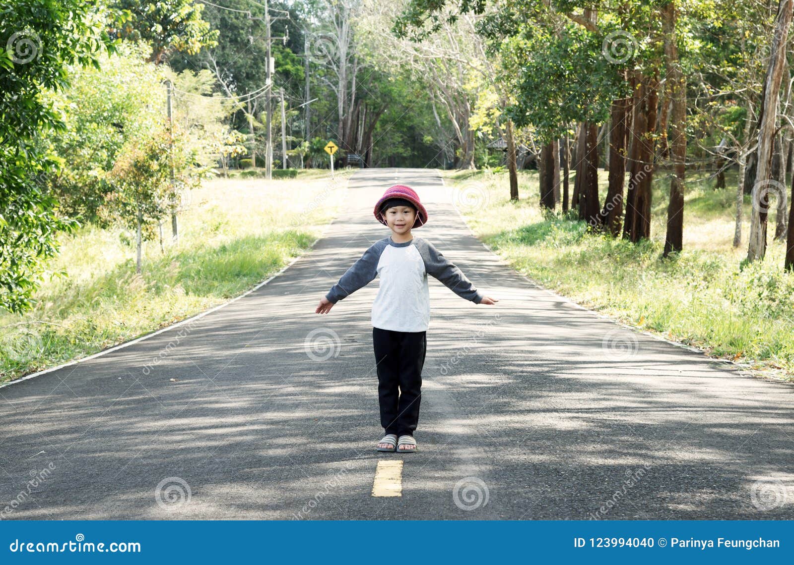 Little Asian Child Standing in the Middle of the Road Stock Photo ...