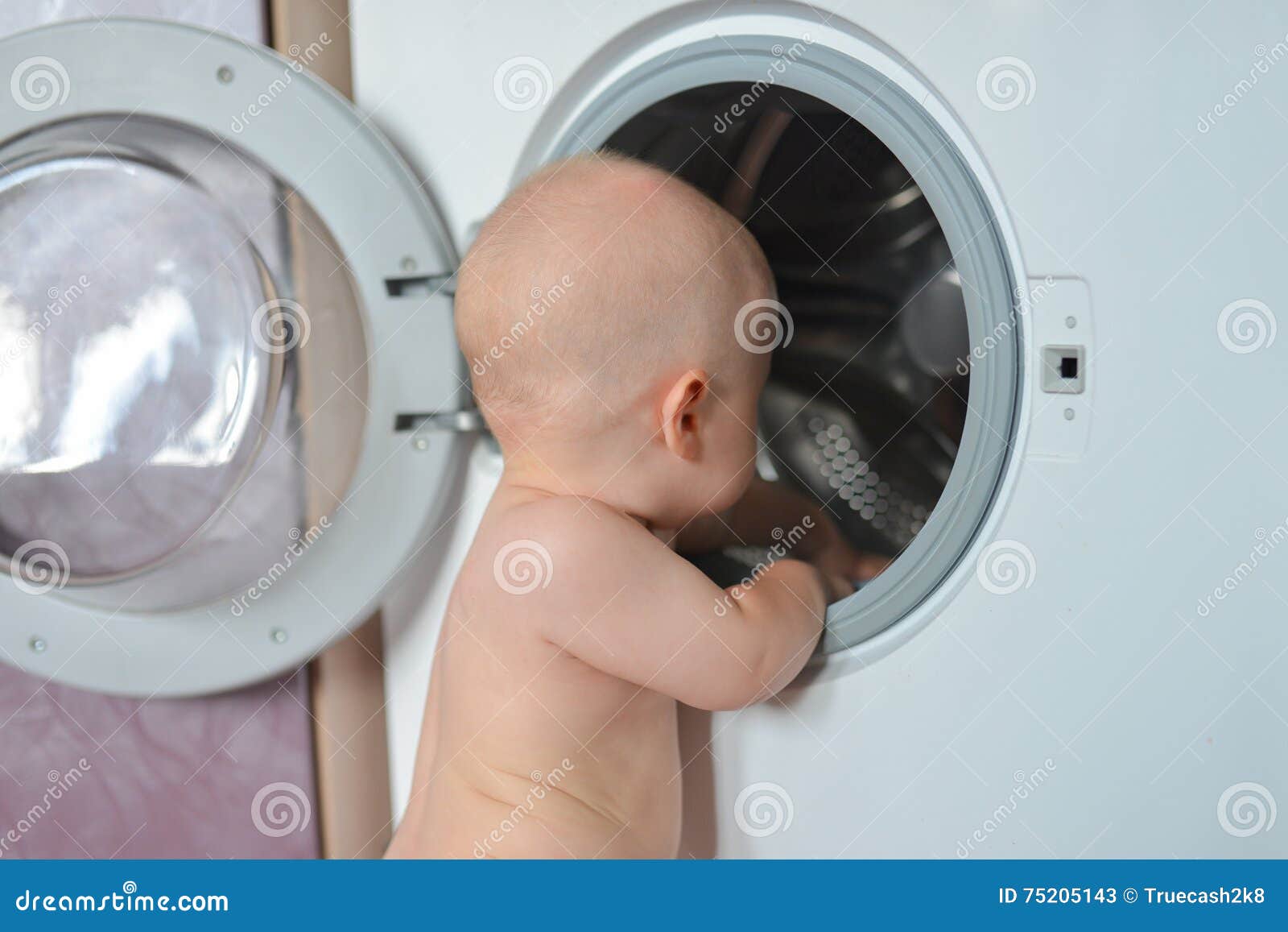 Little Baby Boy Loading Clothes into Washing Machine Stock Image ...