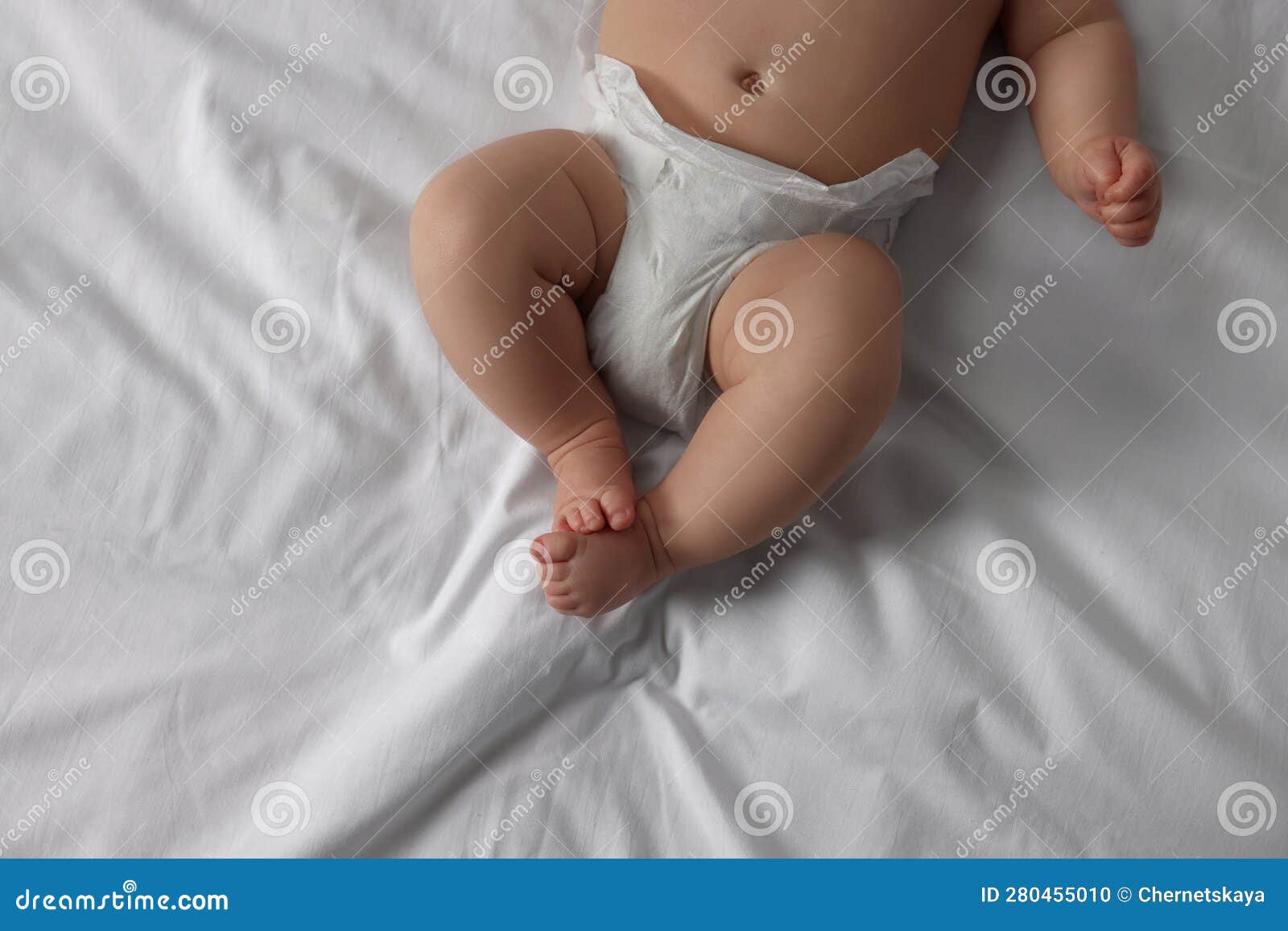 Little Baby in Diaper Lying on Bed, Top View Stock Photo - Image of ...
