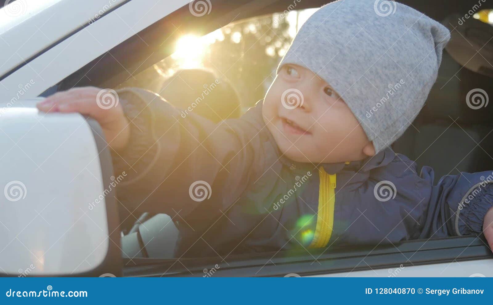A little baby driving car. stock footage. Video of young - 128040870