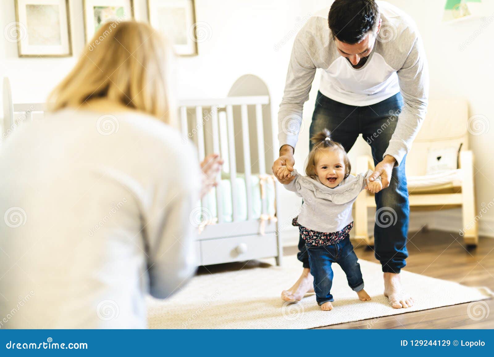 Little Baby Girl First Steps with the Help of Parent Stock Image ...
