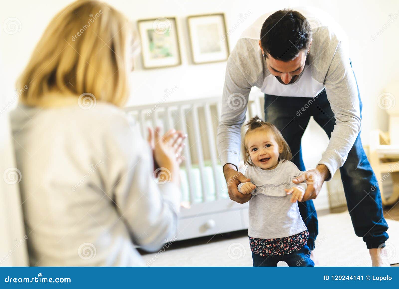 Little Baby Girl First Steps with the Help of Parent Stock Image ...