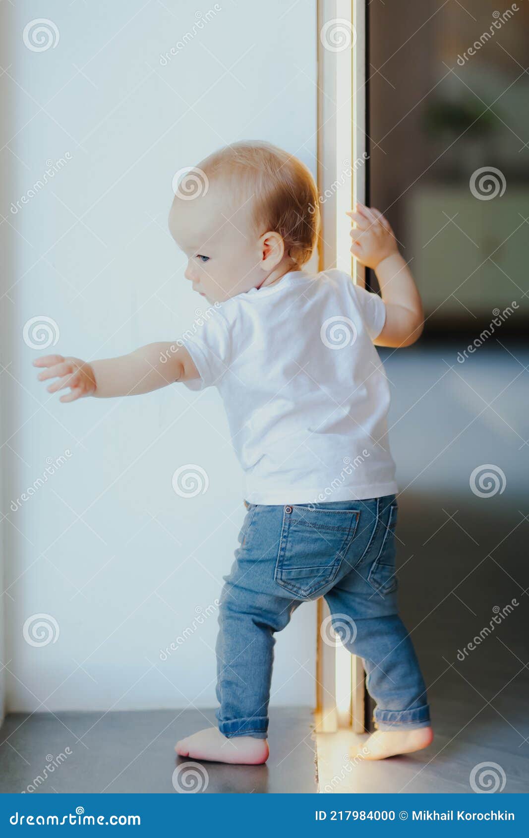 Little baby learns to walk stock photo. Image of year - 217984000