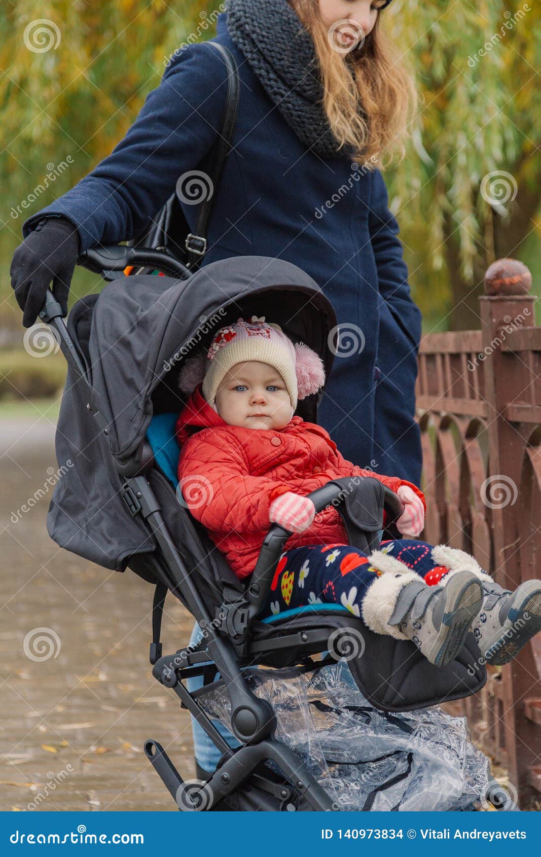 The Little Baby is Sitting in the Pram. Stock Photo - Image of business ...