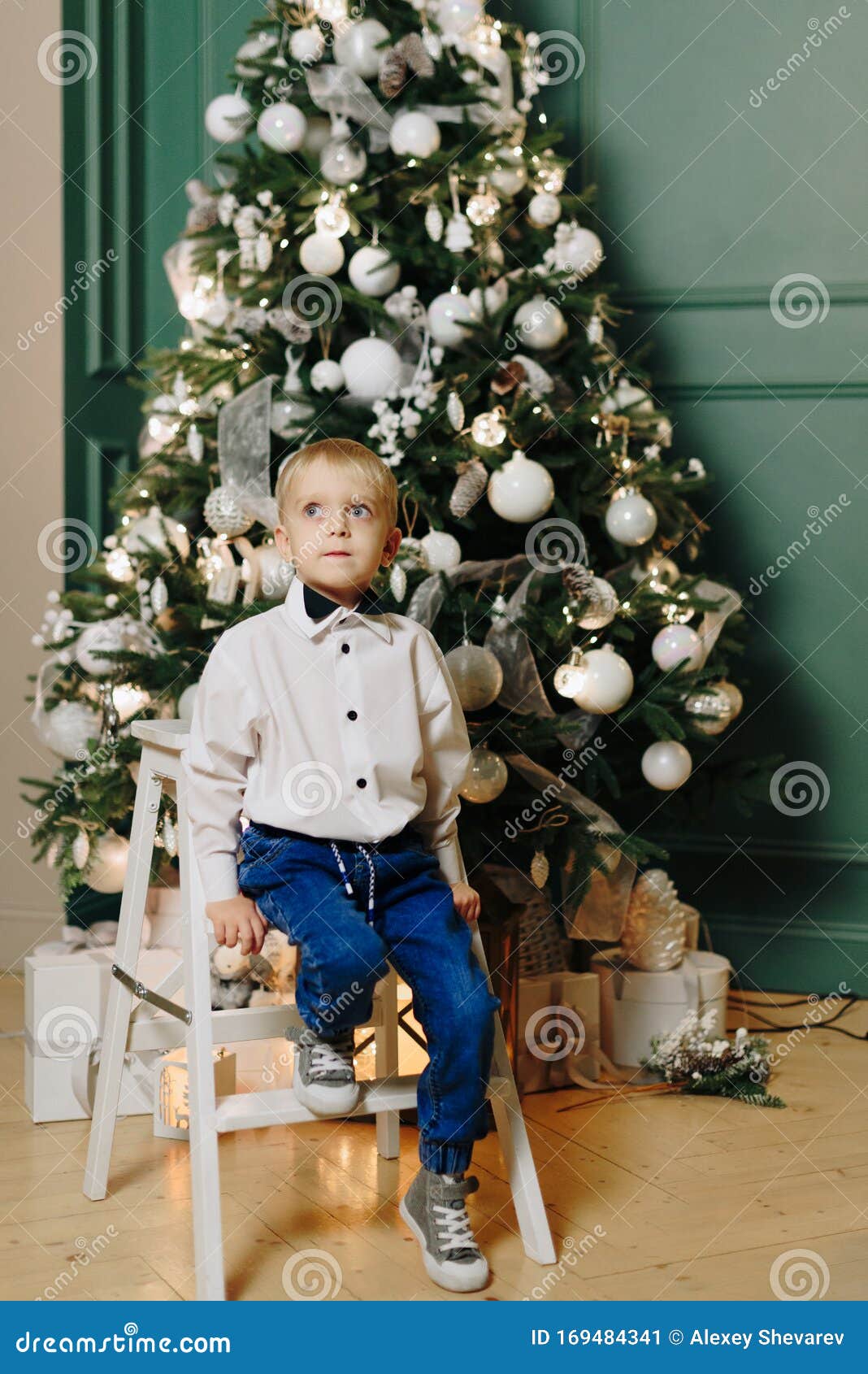 Little Beautiful Boy on the Background of a Decorated Christmas Tree ...