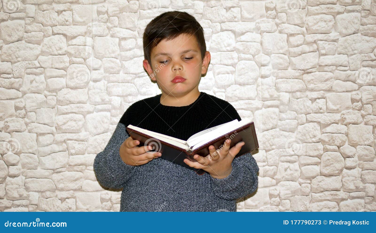 The Little Black Boy Reads a Brown Book. Stock Image - Image of reading ...