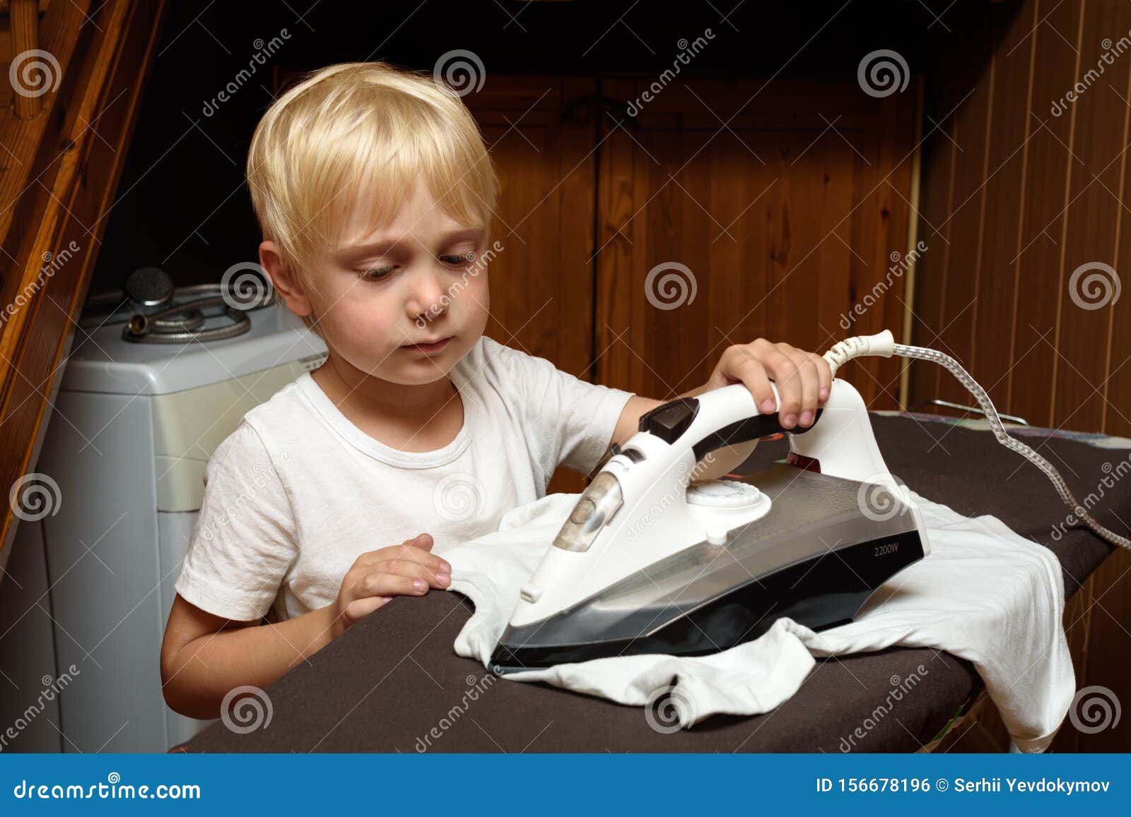 Little Blond Boy Ironing His Clothes. Child Does Homework Stock Photo ...