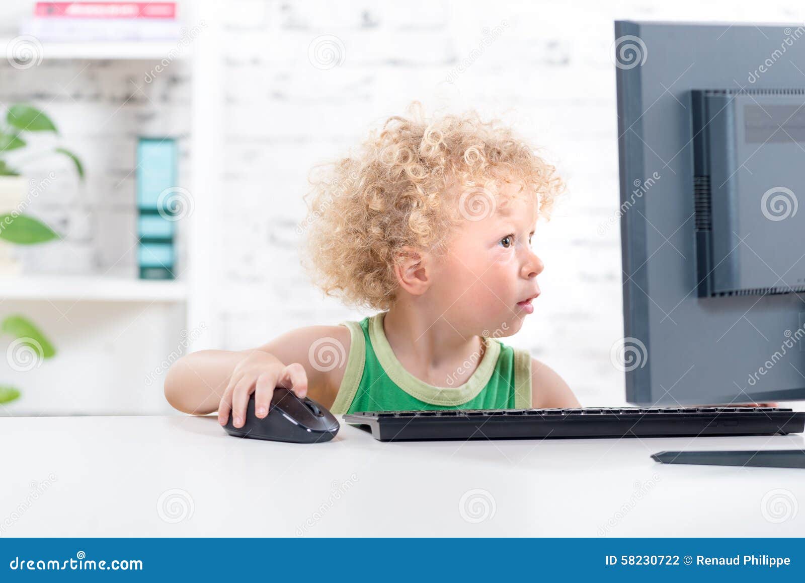 A Little Blond Boy Playing with a Computer Stock Photo - Image of ...