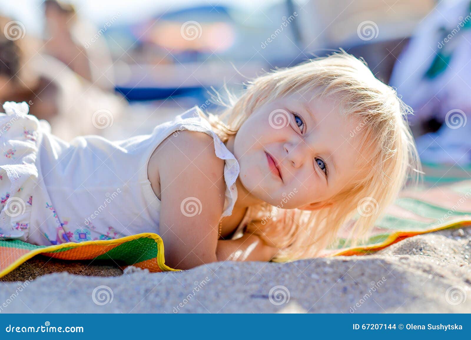 Little Blond Girl is Lying on the Beach Stock Photo - Image of outdoor ...