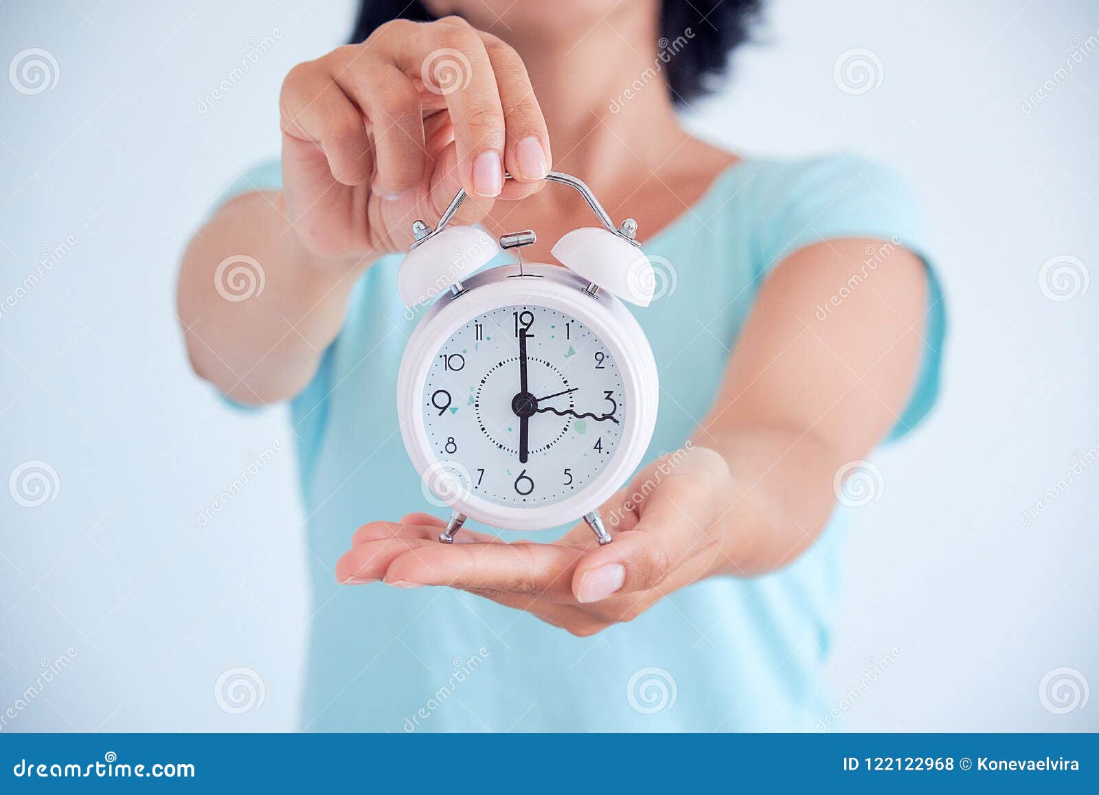 Little Blue Alarm Clock in the Hands of Woman, the Concept of Saving ... Little Blue Alarm Clock in the Hands of Woman, the Concept of Saving ...