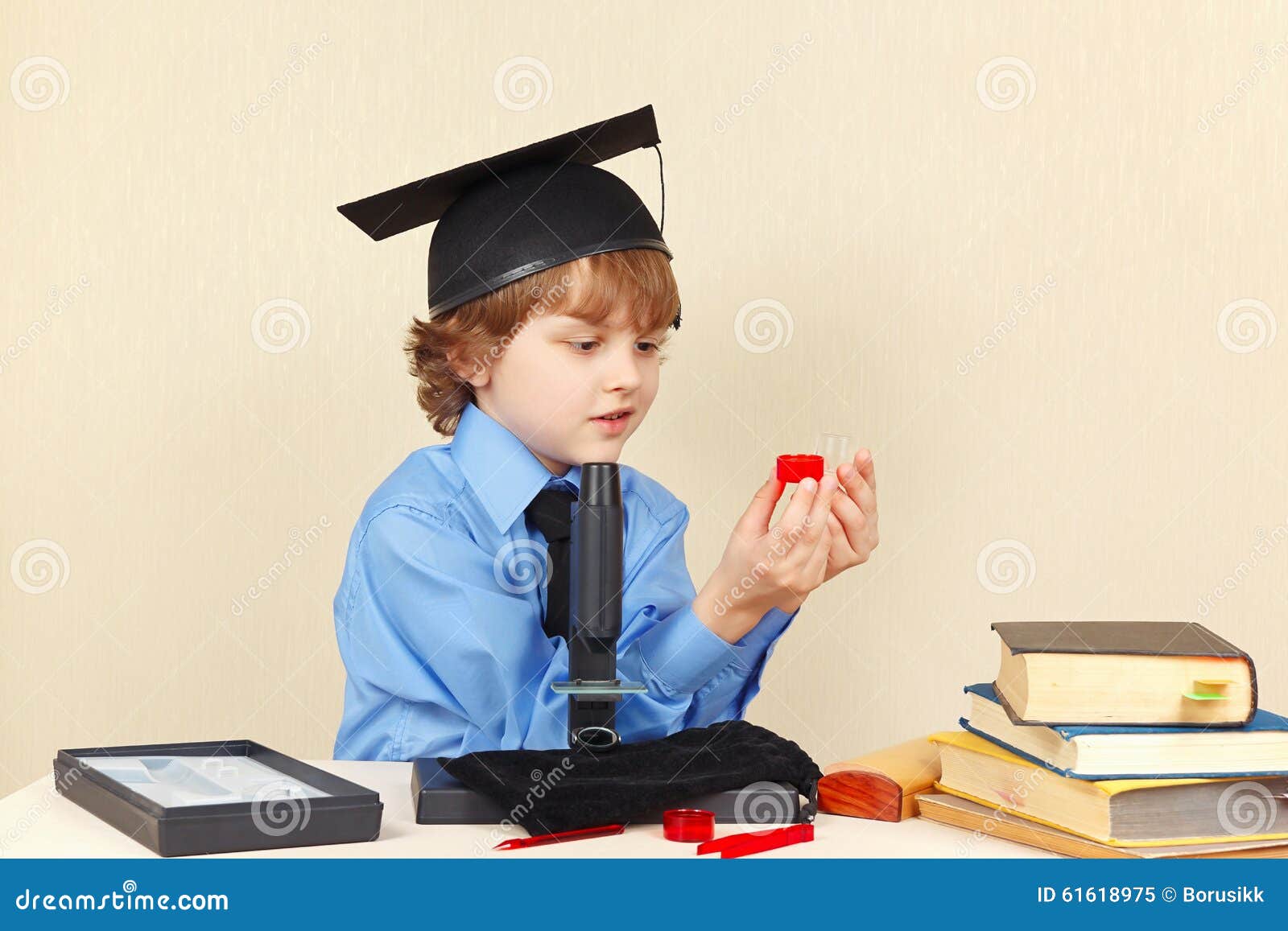Little Boy in Academic Hat Conducts Research with Microscope Stock ...