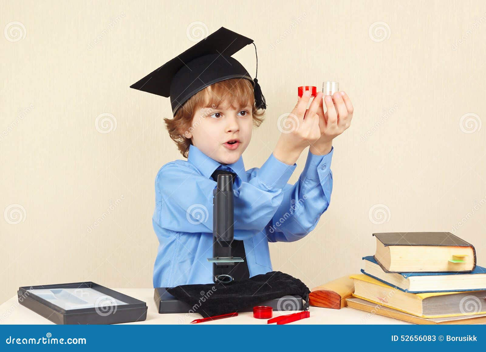 Little Boy in Academic Hat Conducts Scientific Research with Microscope ...