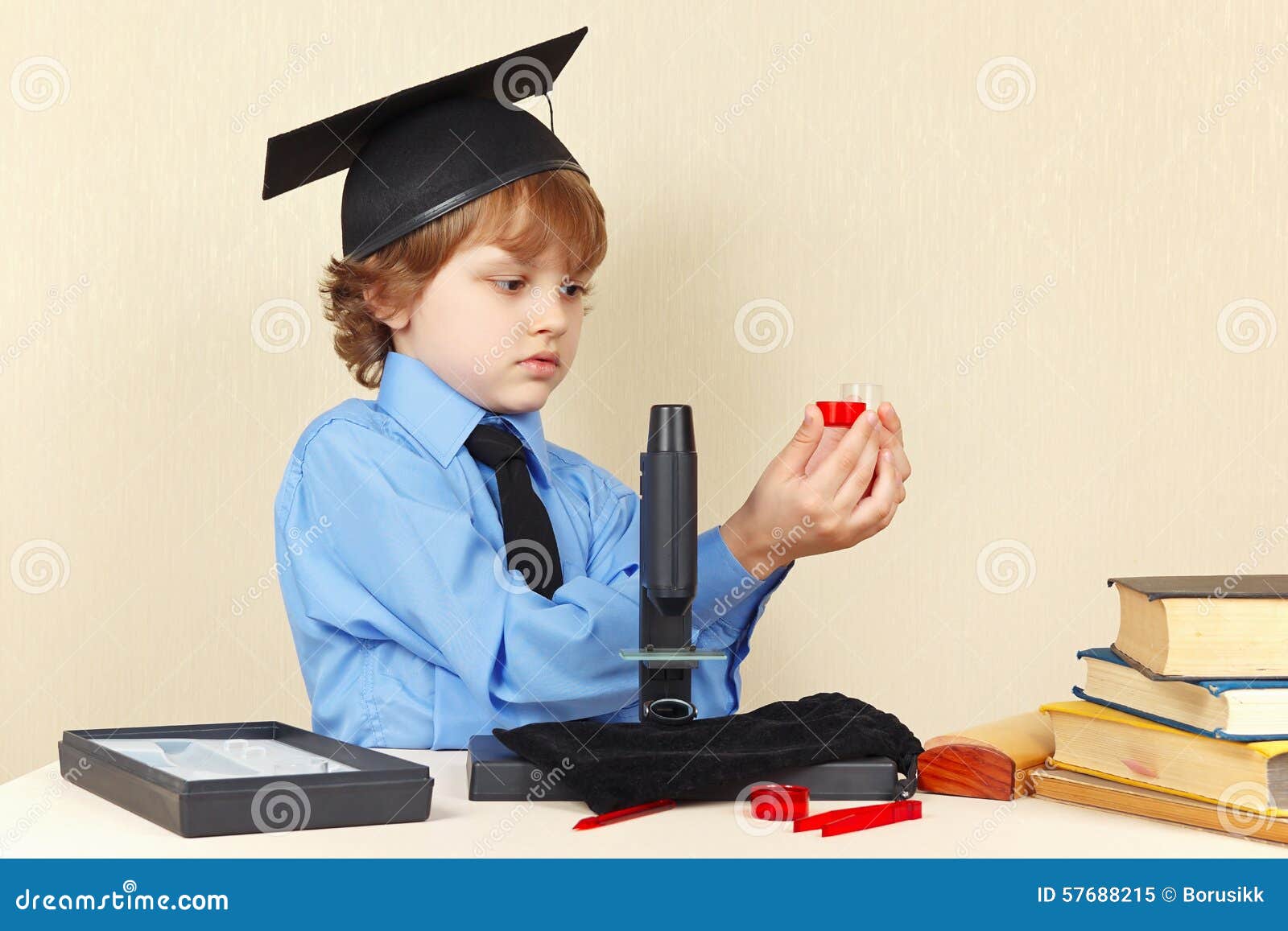 Little Boy in Academic Hat Sees the Results of Research Next To ...