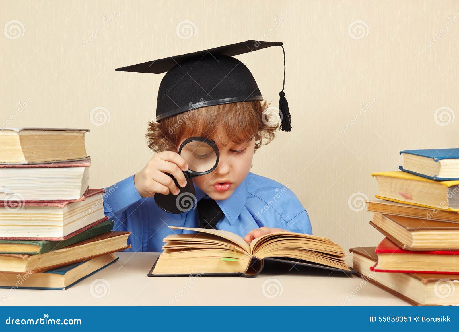 Little Boy in Academic Hat Studies an Old Books with Magnifier Stock ...