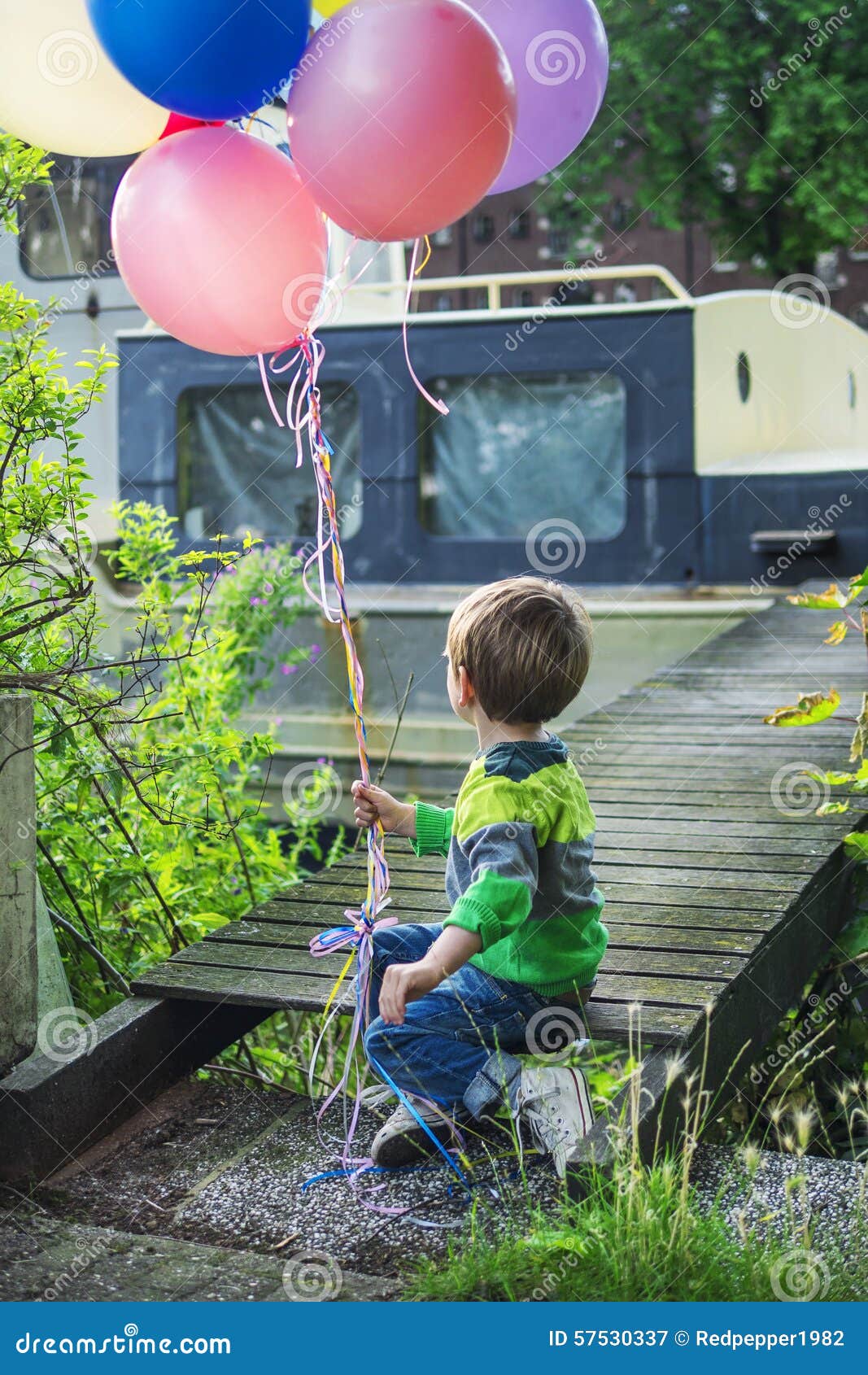 Little boy with balloons stock image. Image of daydream - 57530337