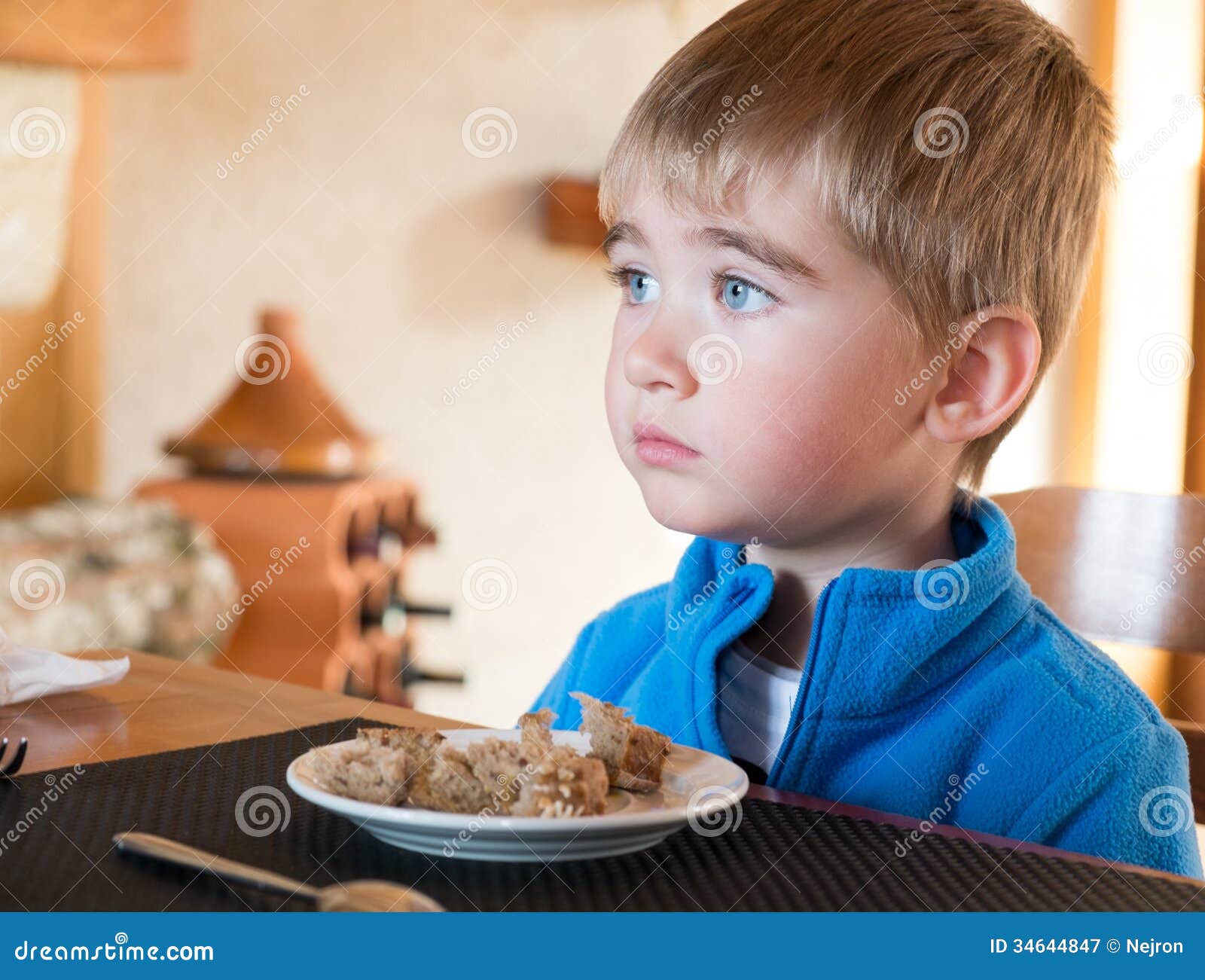 Little boy behind table stock image. Image of melancholy - 34644847