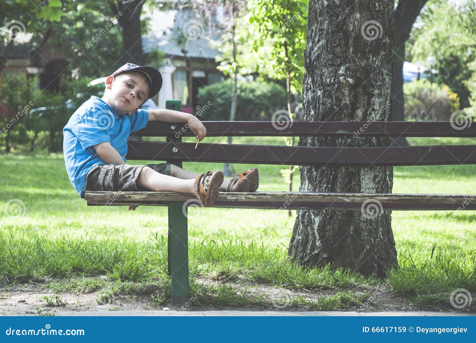 Little boy on a bench stock image. Image of park, person - 66617159