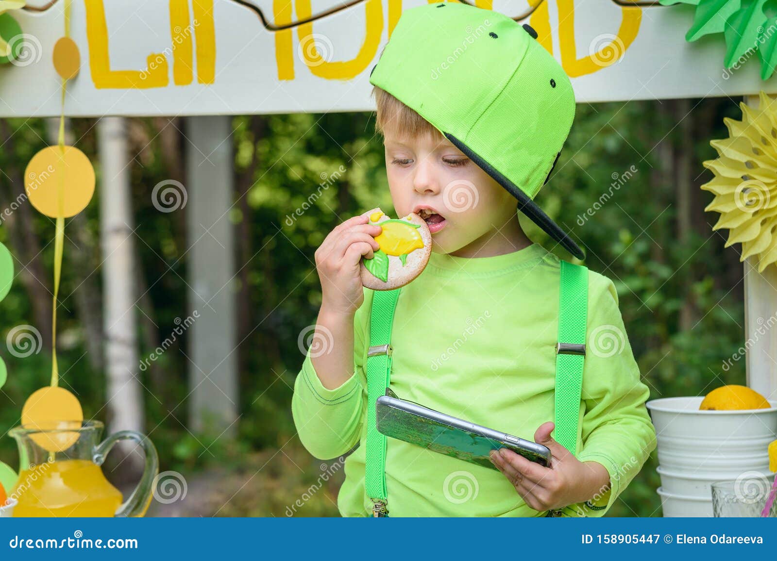 Little Boy with Biscuit Sitting on Lemonade Stand in Park Stock Image ... Little Boy with Biscuit Sitting on Lemonade Stand in Park Stock Image ...