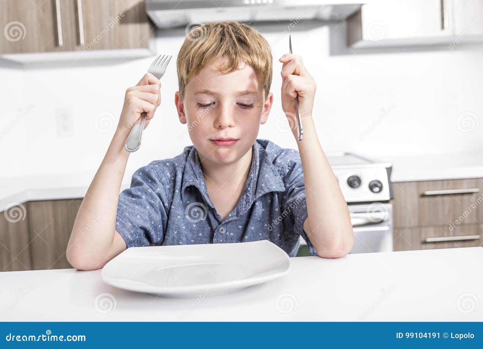 Little Boy with Bored Grumpy Expression Sitting at a Table Stock Image ...