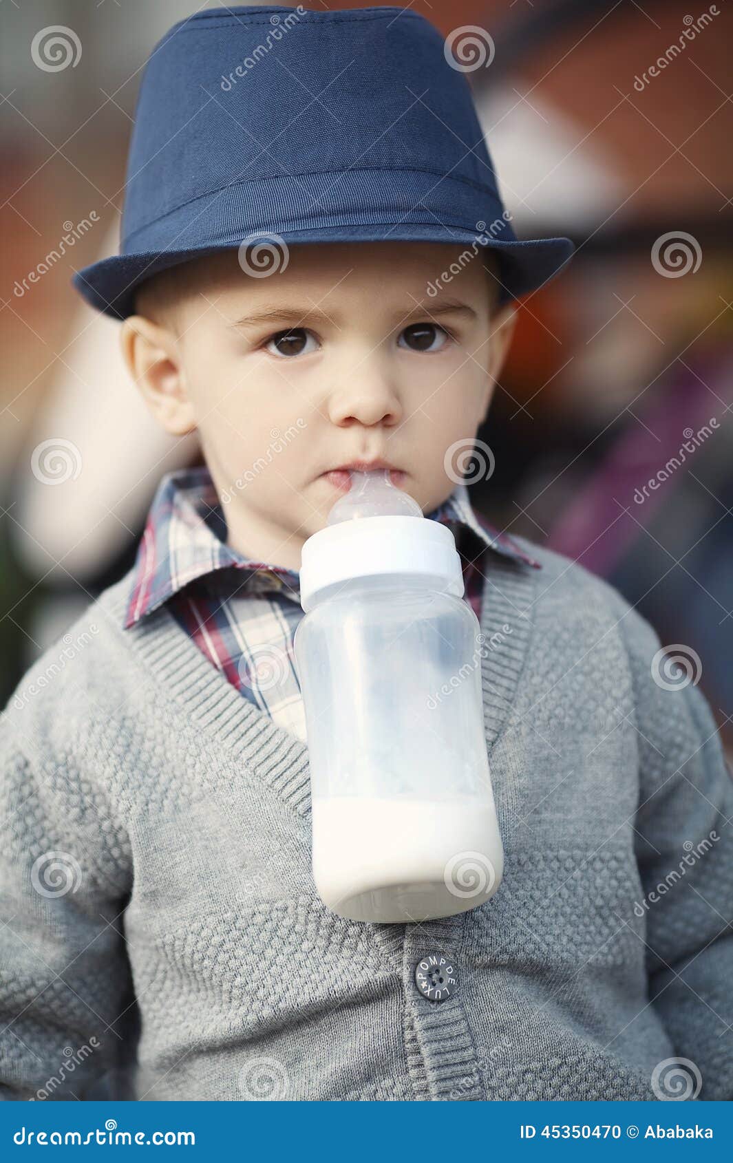 Little Boy with Bottle in Mouth Stock Photo - Image of drinking, blue ...