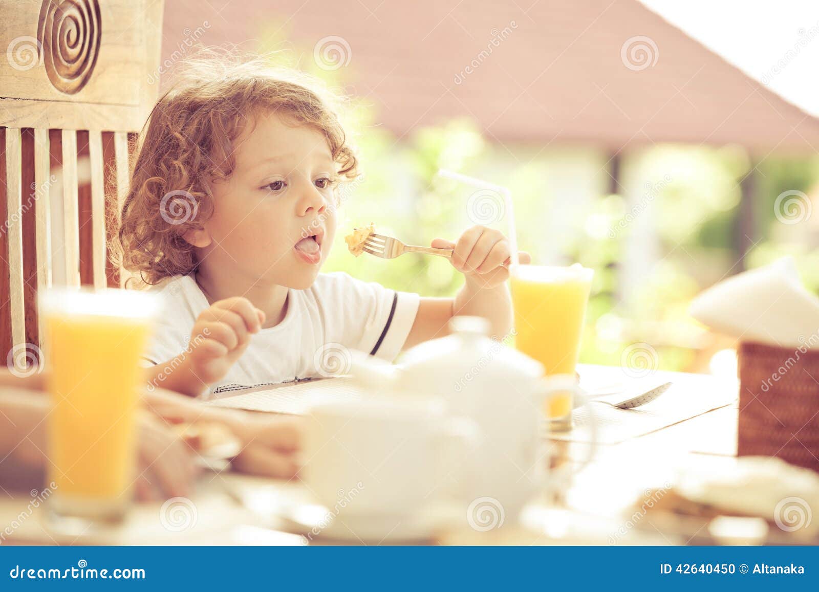 Little boy at breakfast stock photo. Image of hand, childhood - 42640450