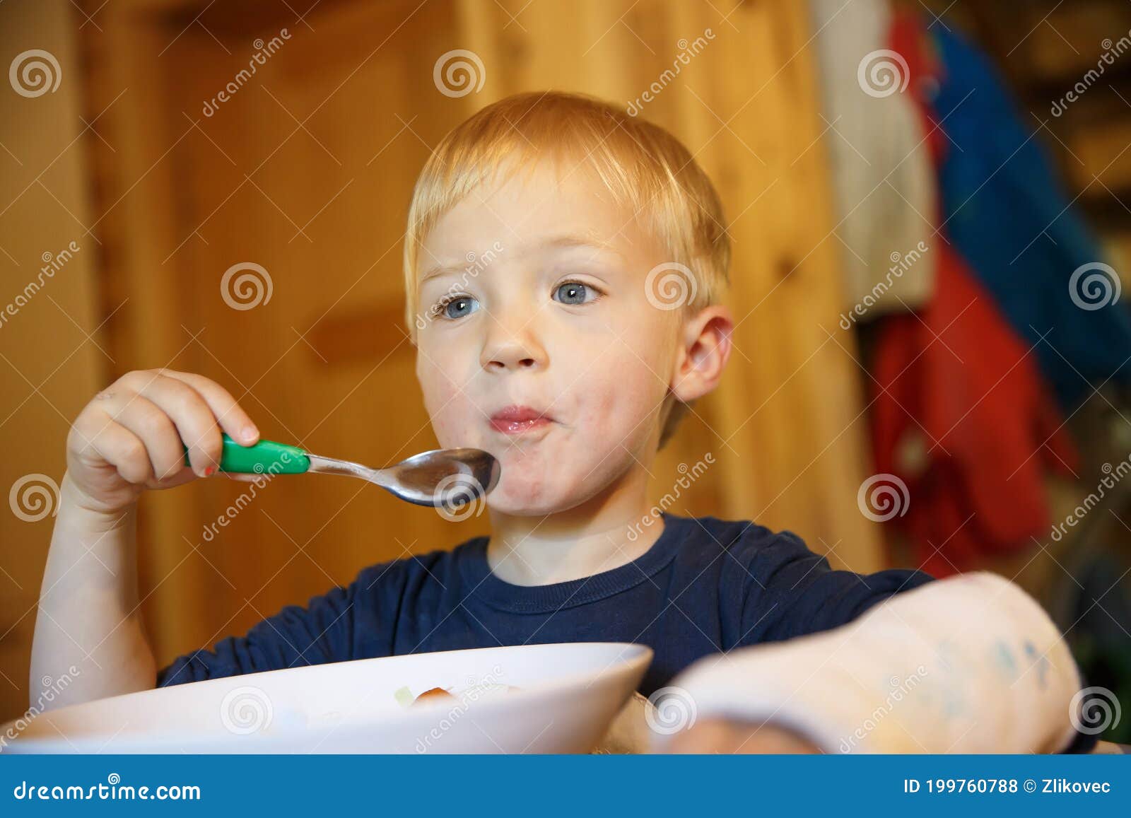 Little Boy with a Broken Wrist Eating at the Table. Boy with a Plaster ...