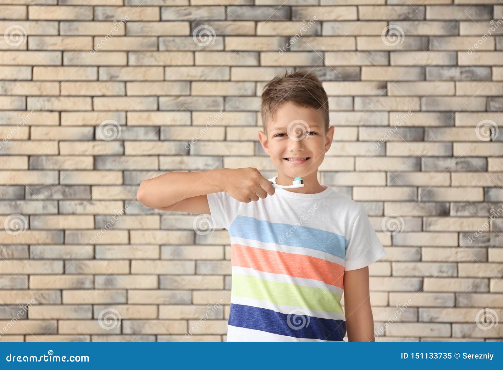 Little Boy Brushing Teeth Against Brick Wall Stock Image - Image of ...