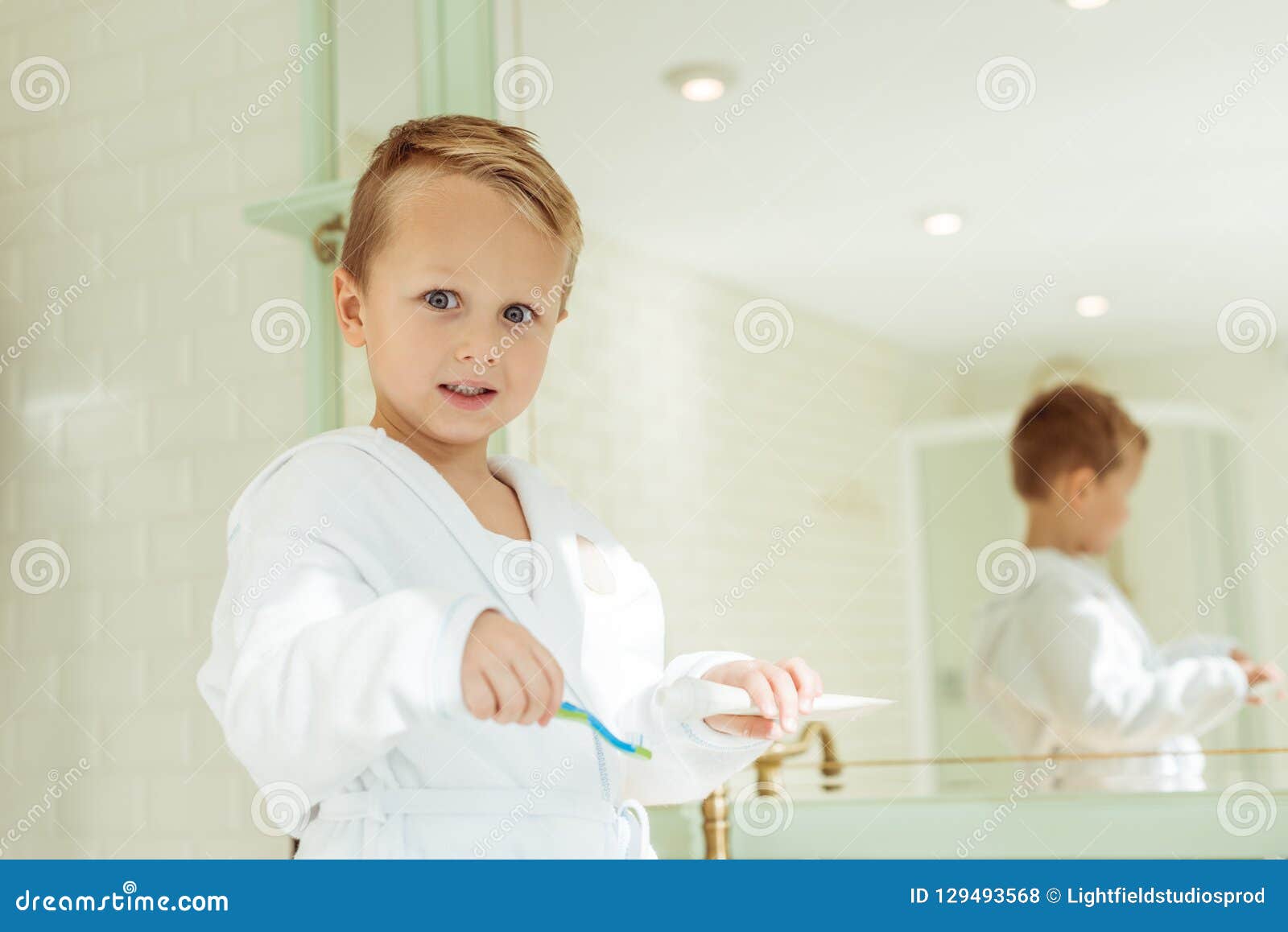 Cute Little Boy Holding Toothbrush with Toothpaste and Looking Stock ...