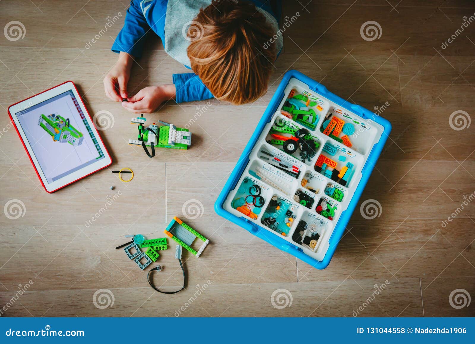 Little Boy Building Robot and Programming it with Touch Pad Stock Photo ... Little Boy Building Robot and Programming it with Touch Pad Stock Photo ...