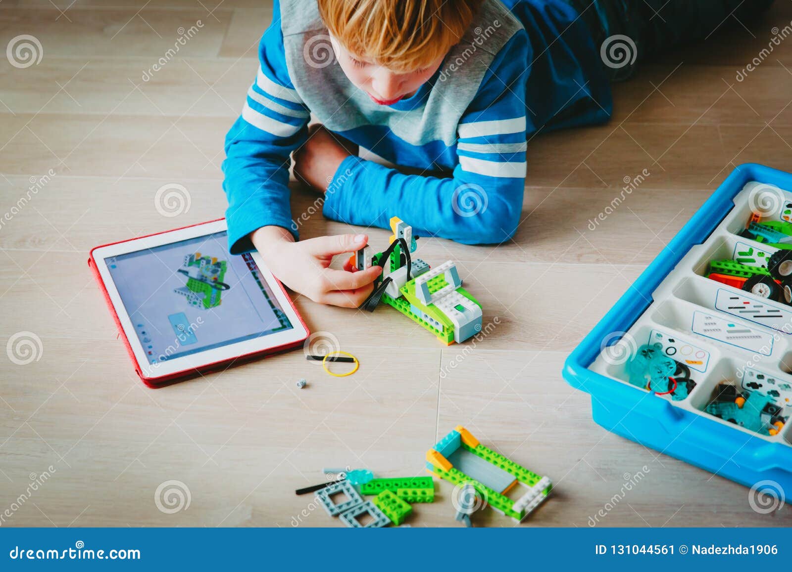 Little Boy Building Robot and Programming it with Touch Pad Stock Image ... Little Boy Building Robot and Programming it with Touch Pad Stock Image ...