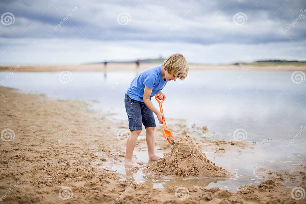 Little Boy Building Sand Castle Stock Image - Image of happy, active ...