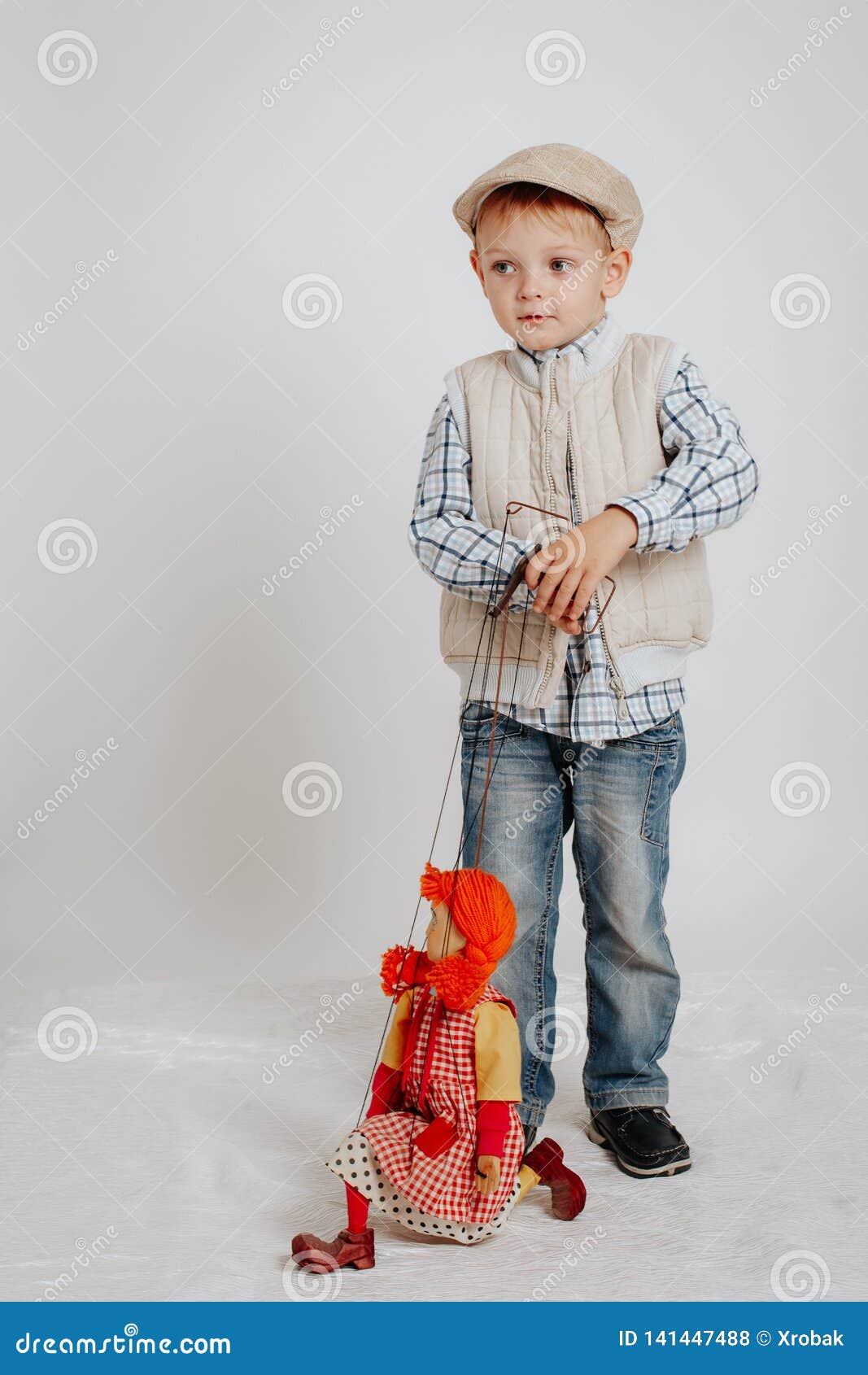 Little Boy in Cap Standing with a Puppet Doll Stock Photo - Image of ...