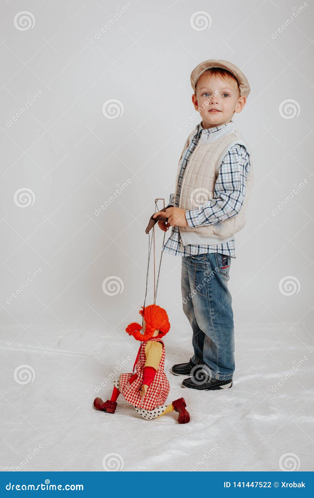 Little Boy in Cap Standing with a Puppet Doll Stock Photo - Image of ...