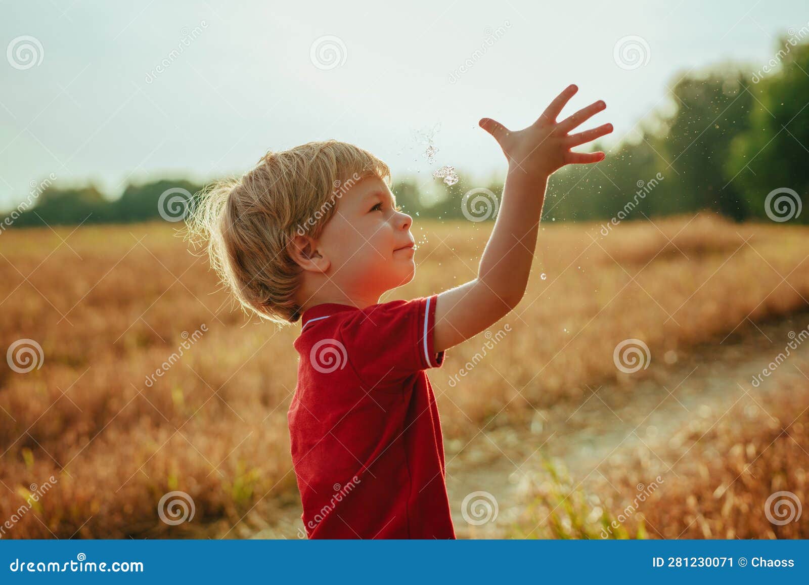 Little Boy Catches Water Droplets in the Air Stock Image - Image of ...