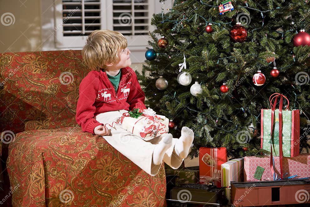 Little Boy by Christmas Tree with Present in Lap Stock Photo - Image of ...